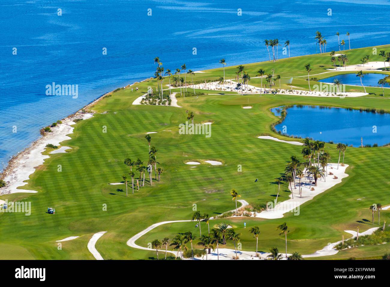 Waterfront golf course in Florida. Sports grounds with green grass in ...