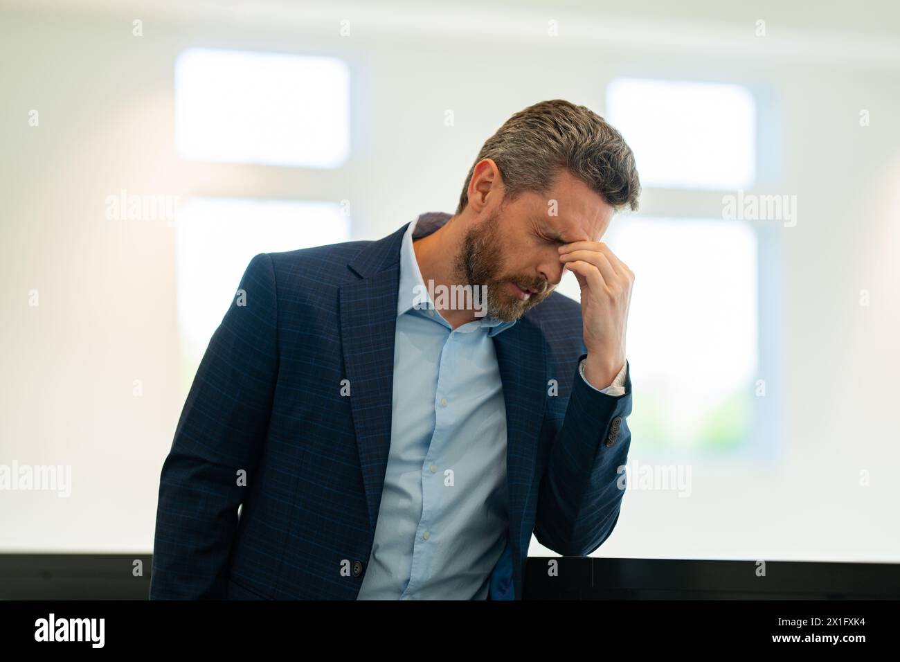 Man with sinus headache, tension or cluster headache, close up portrait ...