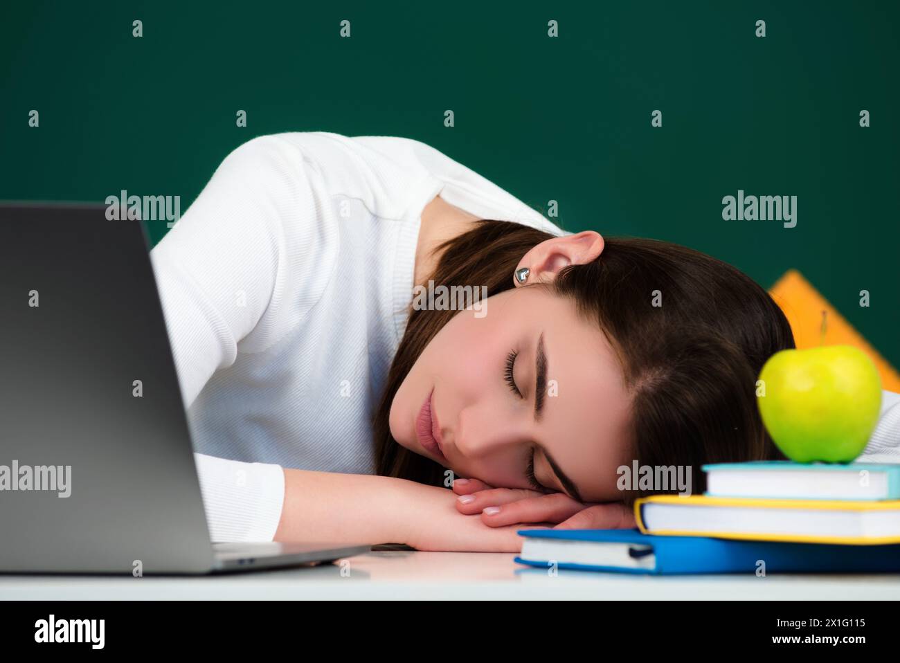 Student sleeping during a lecture in a classroom. Portrait of tired ...