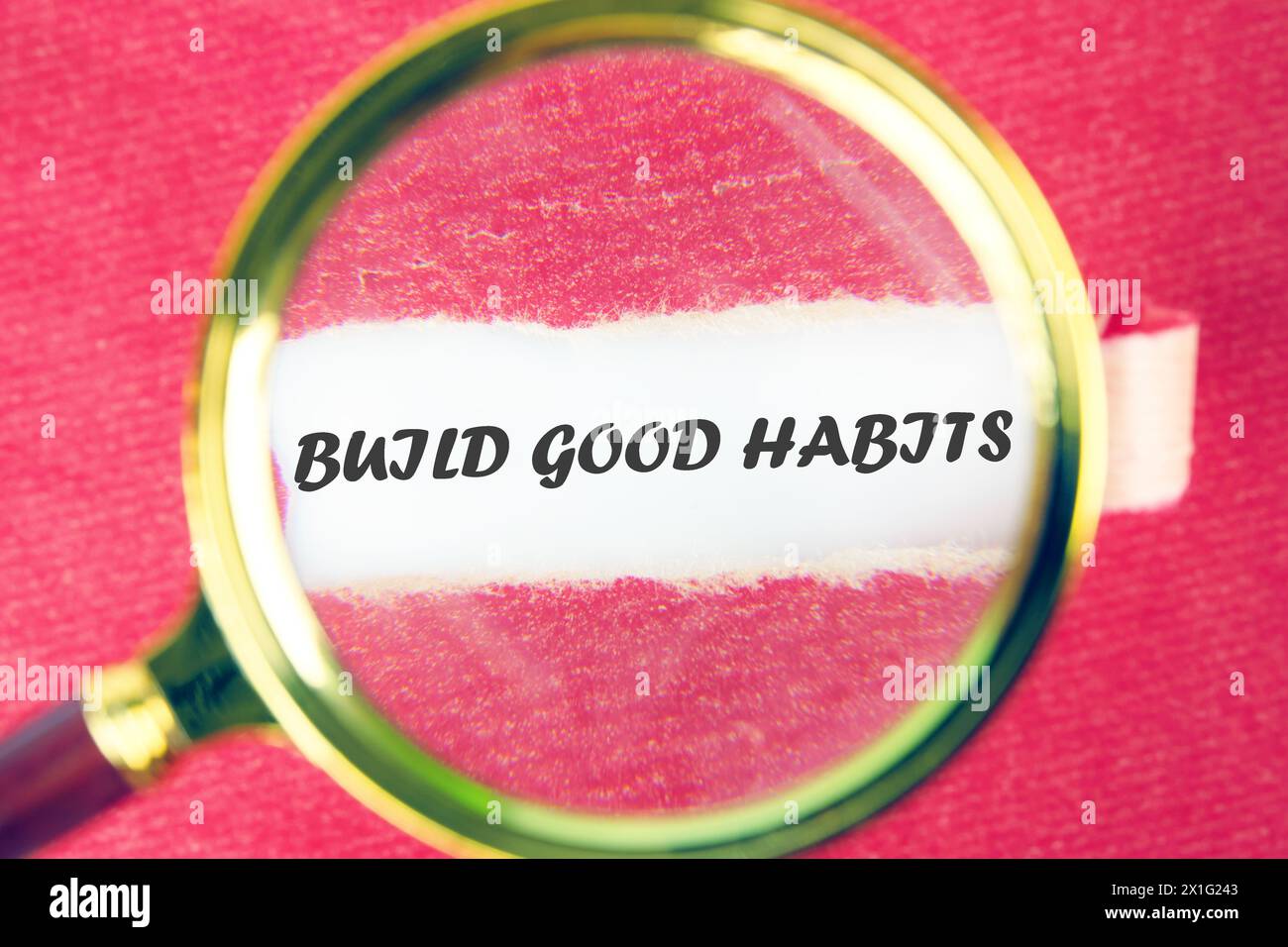 BUILD GOOD HABITS motivational concept text through a magnifying glass ...