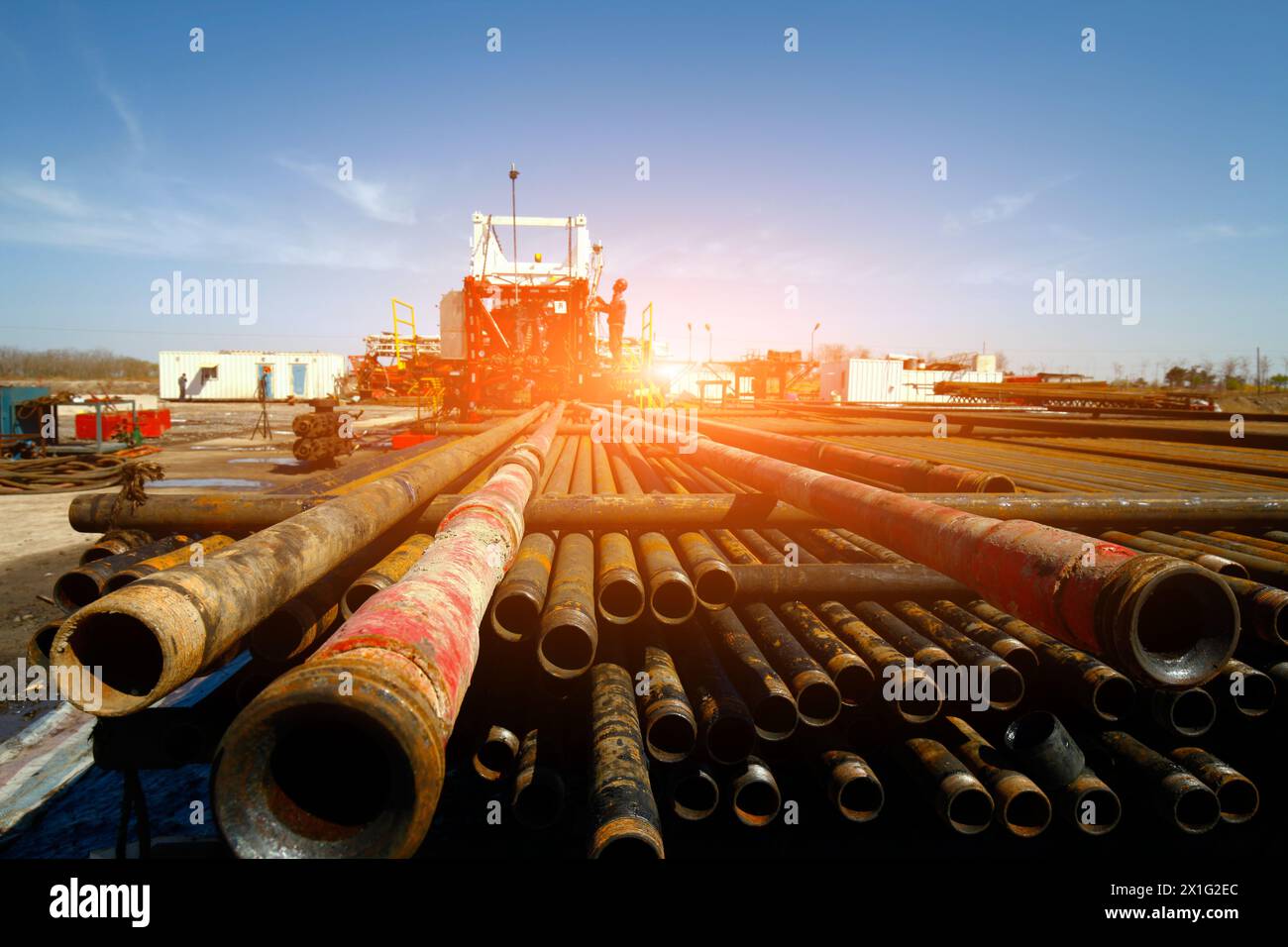 Oil pipe and oil drilling rig equipment Stock Photo - Alamy