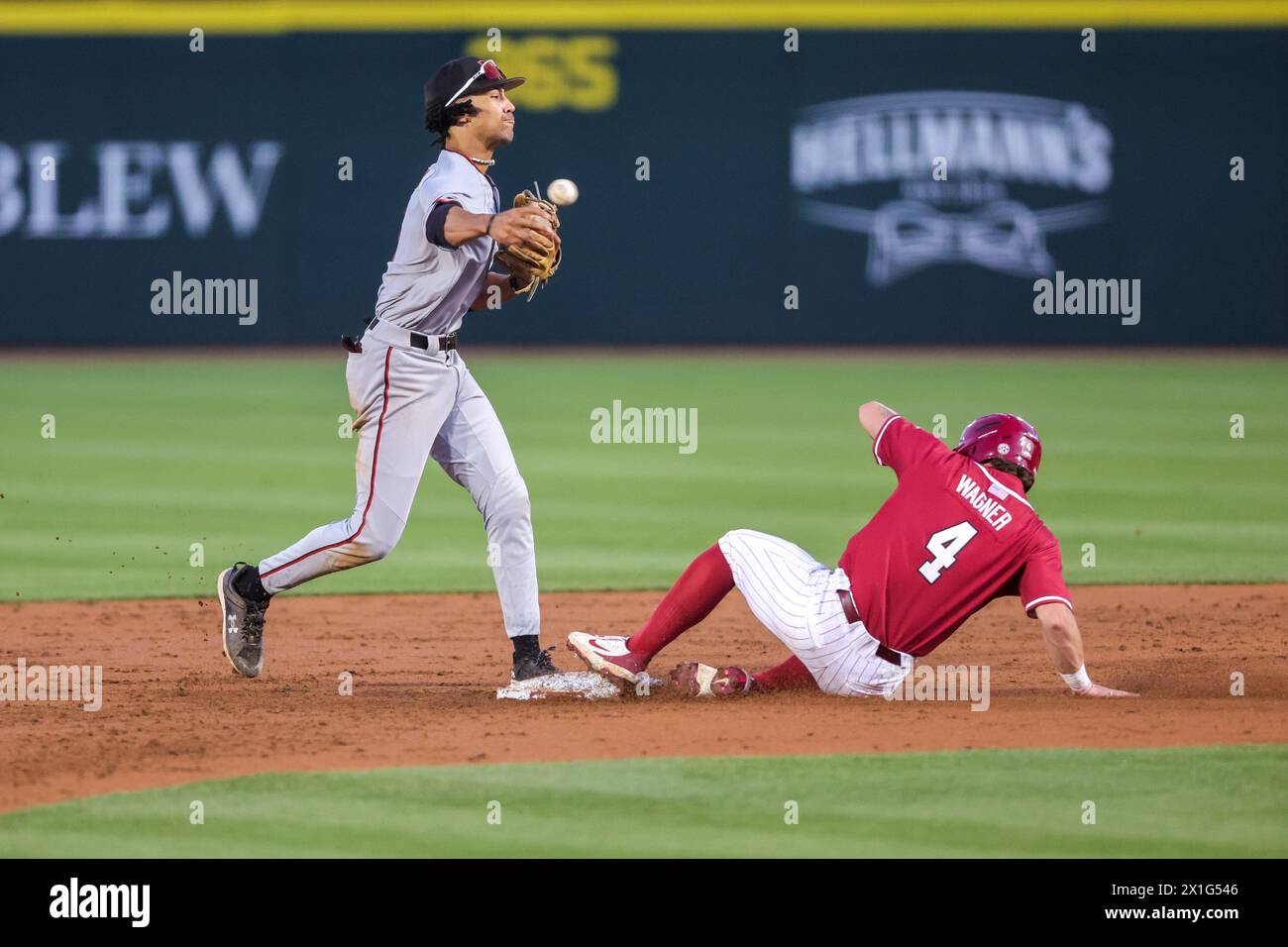 April 16, 2024: Arkansas base runner Jack Wagner #4 slides at the feet ...