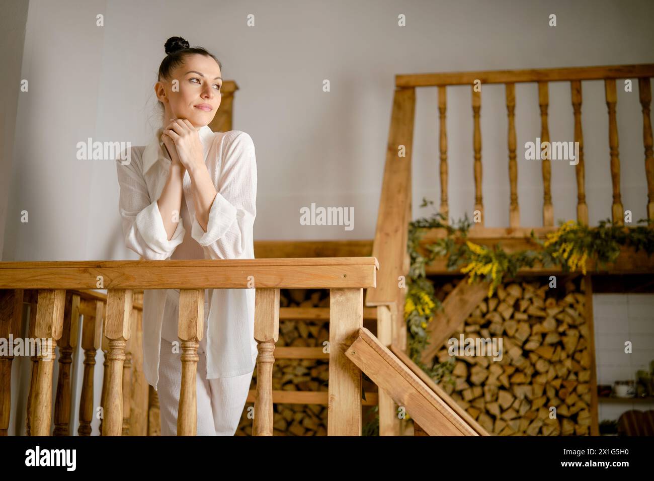 A woman looks thoughtfully into the distance while standing on a flight ...