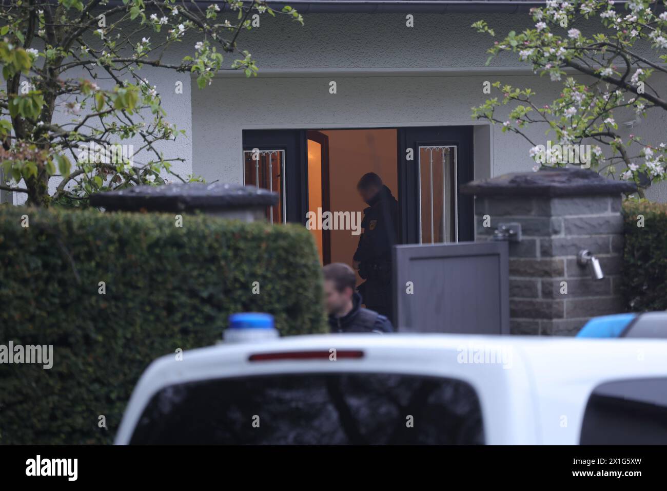 Solingen, Germany. 17th Apr, 2024. Police officers stand at a house ...