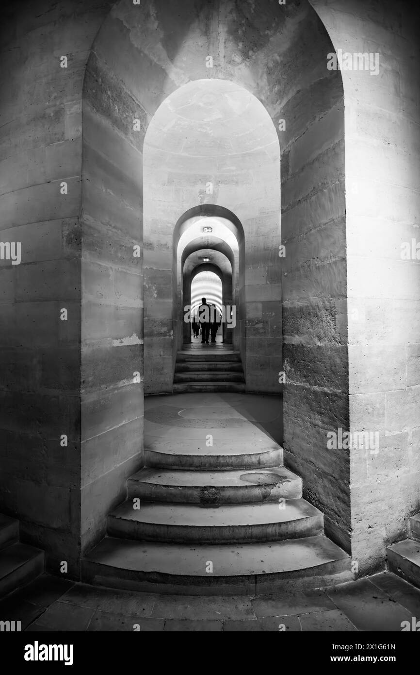 Stone arches lead down to the crypt of the Pantheon in Paris, with ...