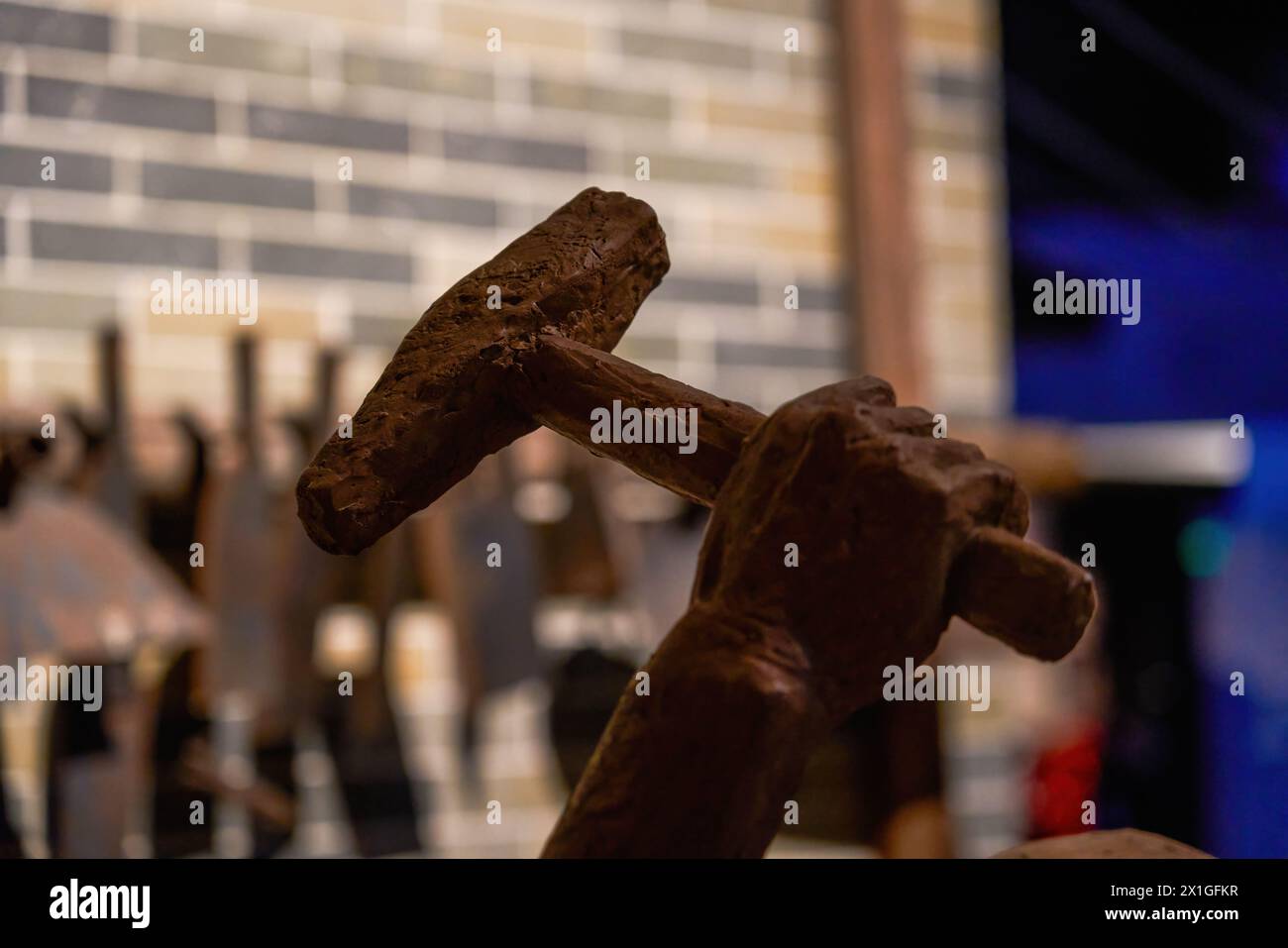 Close-up of a blacksmith sculpture's hand holding a hammer Stock Photo ...