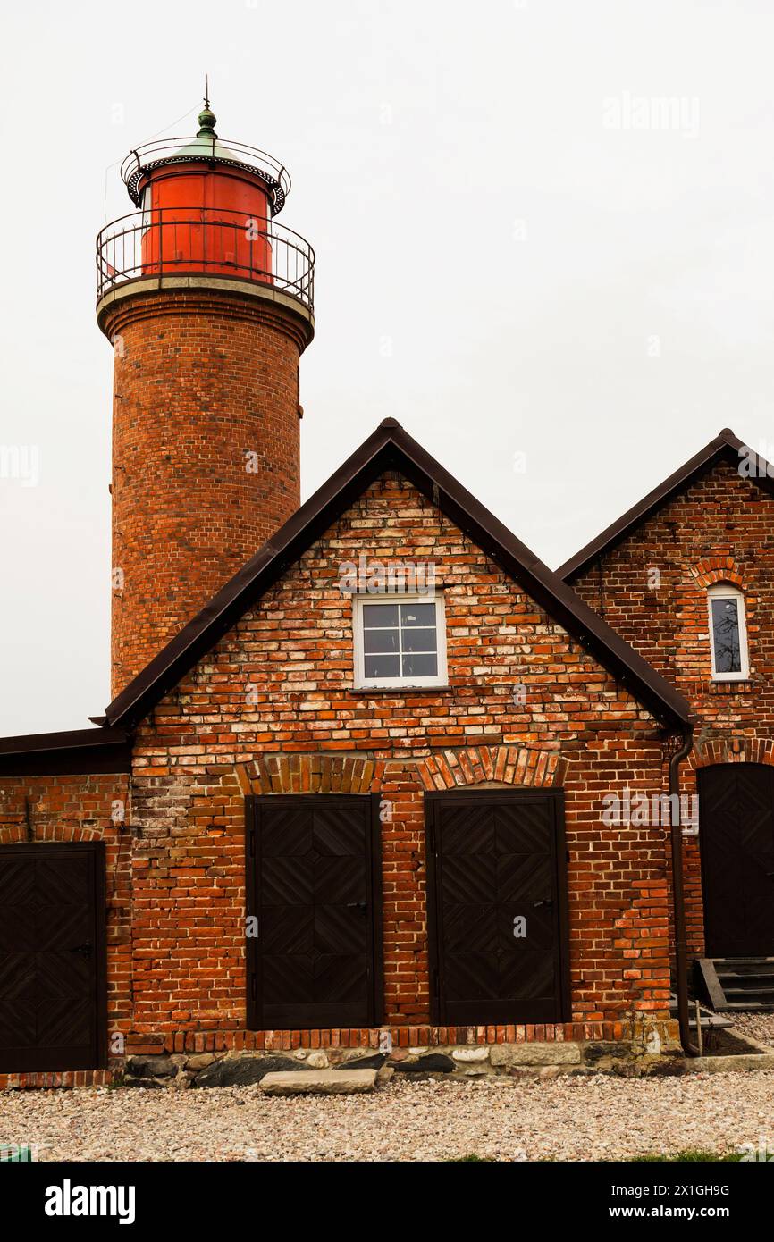 A charming brick cottage with a wooden lighthouse perched on its roof ...