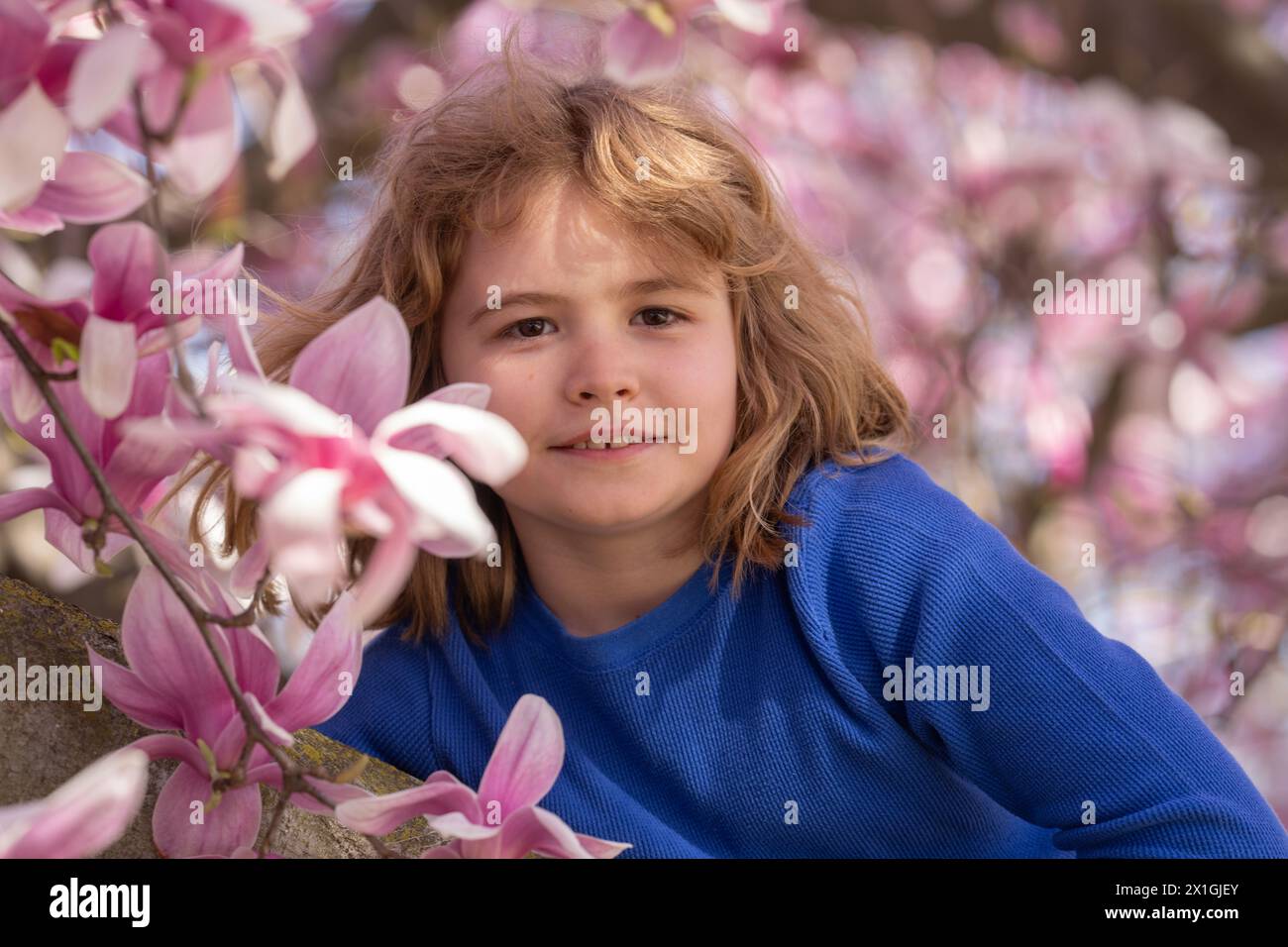 Kid in spring cherry blossom park. Happy childhood. Spring holidays ...