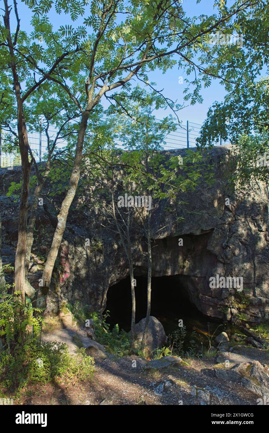 Old cave under cliff that was used as crew shelter and storage area ...