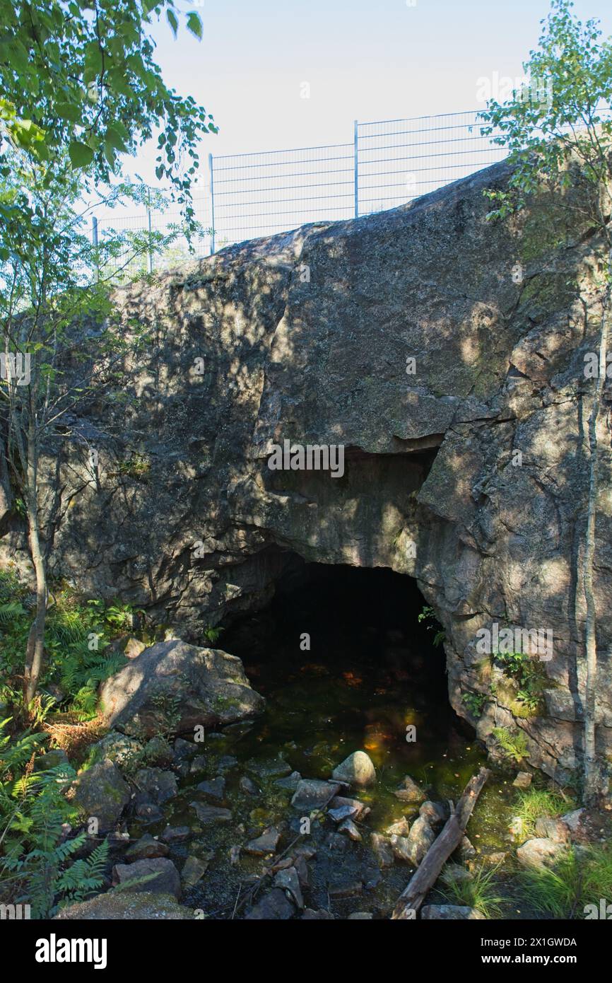 Old cave under cliff that was used as crew shelter and storage area ...