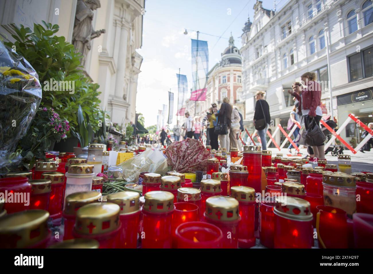 Flowers and candles are placed at the scenes of an amok car driver ...