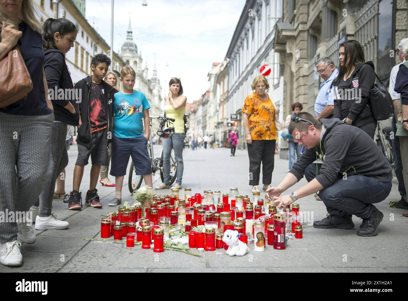 Flowers and candles are placed at the scenes of an amok car driver ...