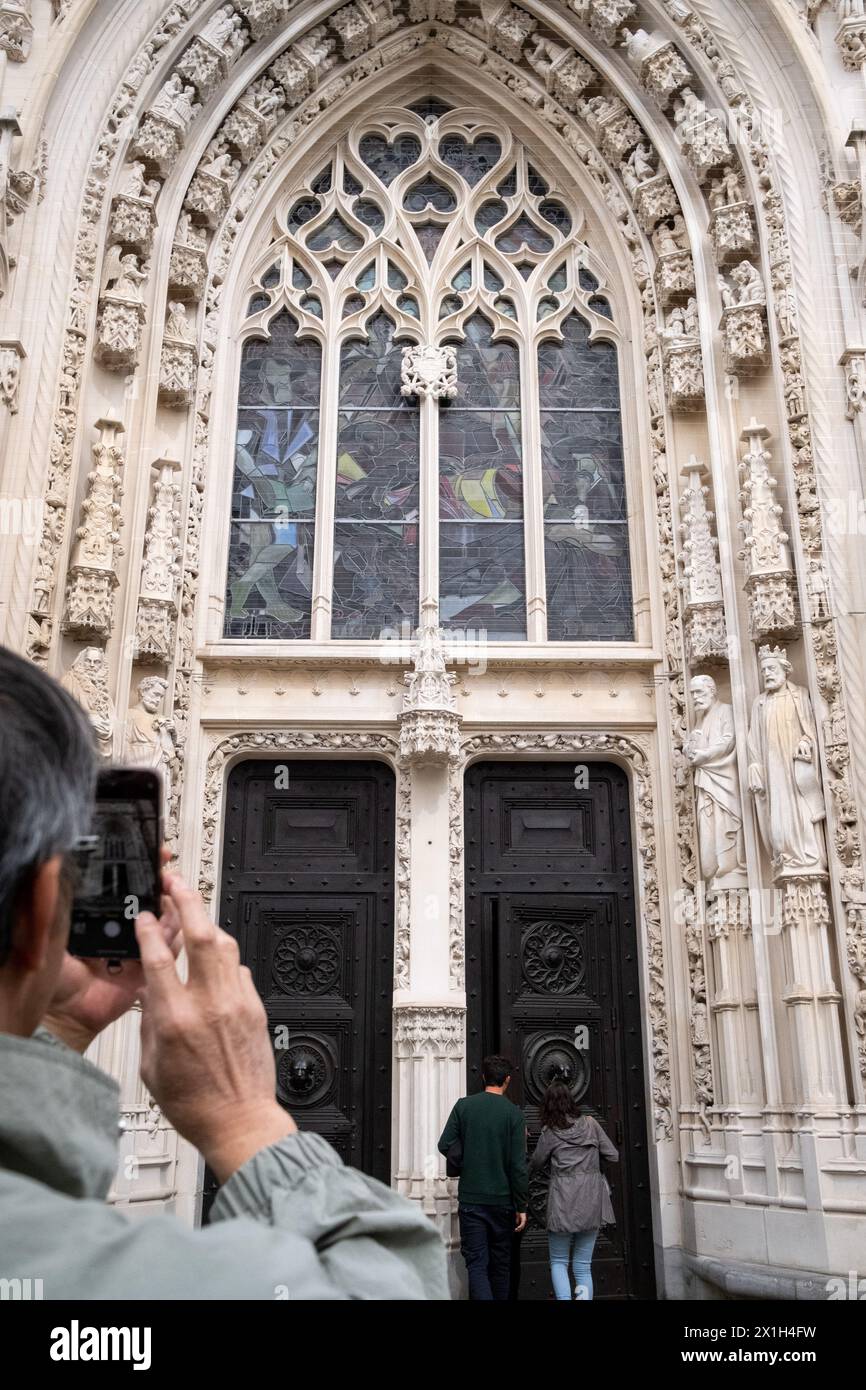 Tourists at the entrance to the Cathedral of Lausanne, an imposing 12th ...