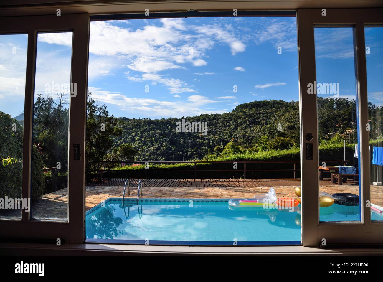 Window View to a Beautiful Swimming Pool by the Mountains in the ...