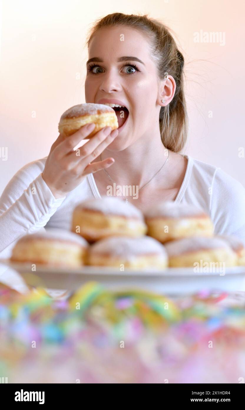Feature - Woman eating Jam filled doughnuts, in Austria called Krapfen ...