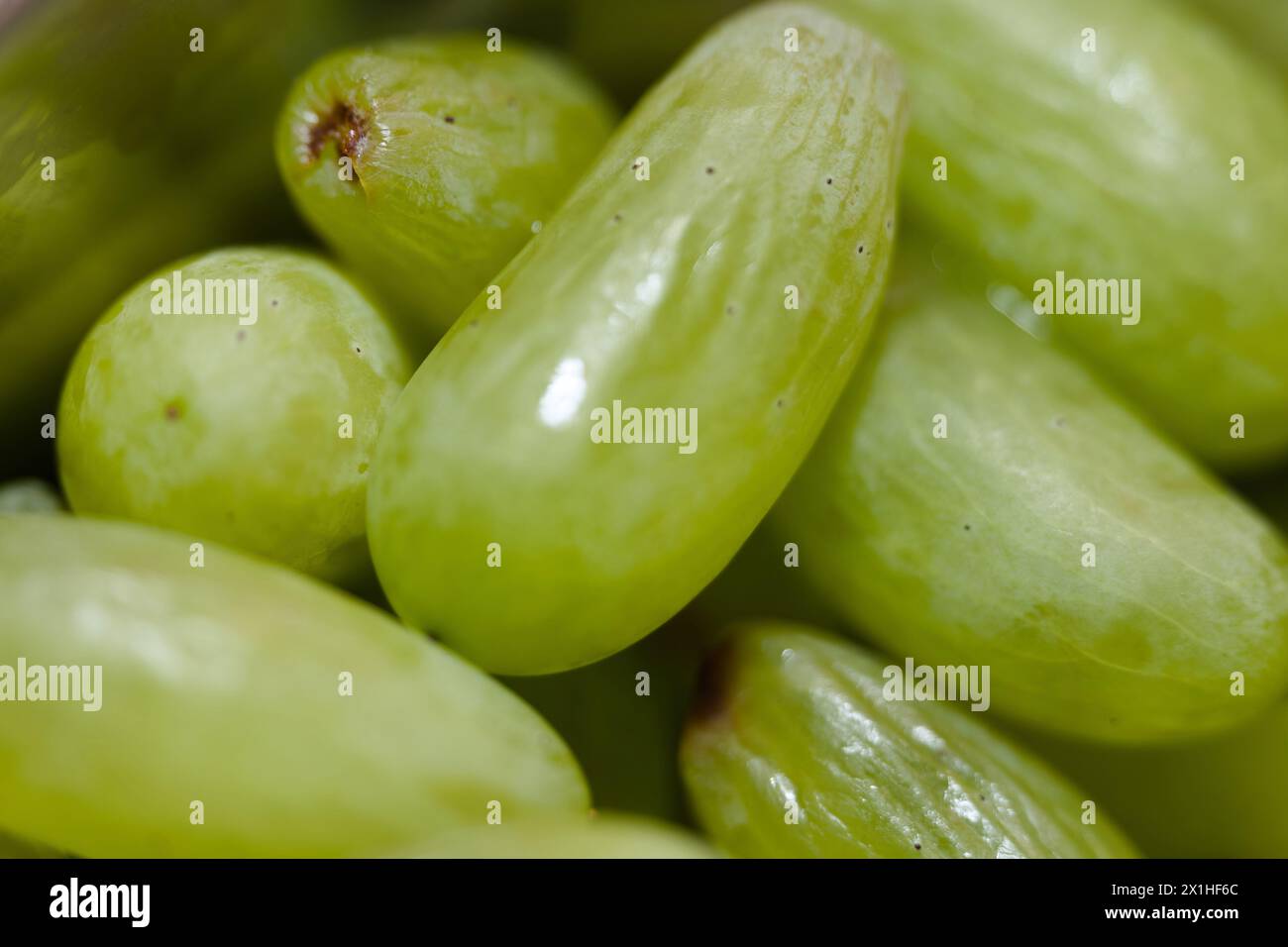 This close-up photo captures the intricate details of a bunch of ripe ...