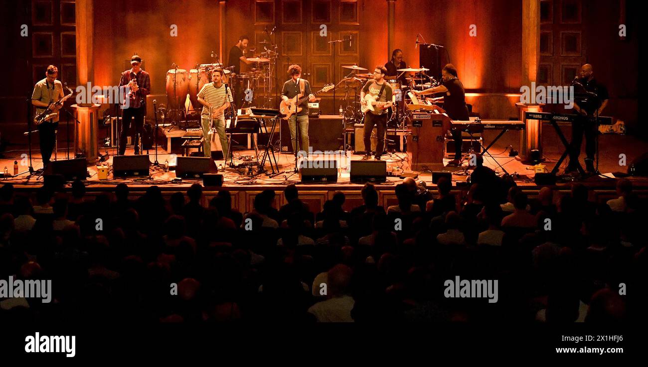 Snarky Puppy band leader, Michael League (C), performs on stage during ...