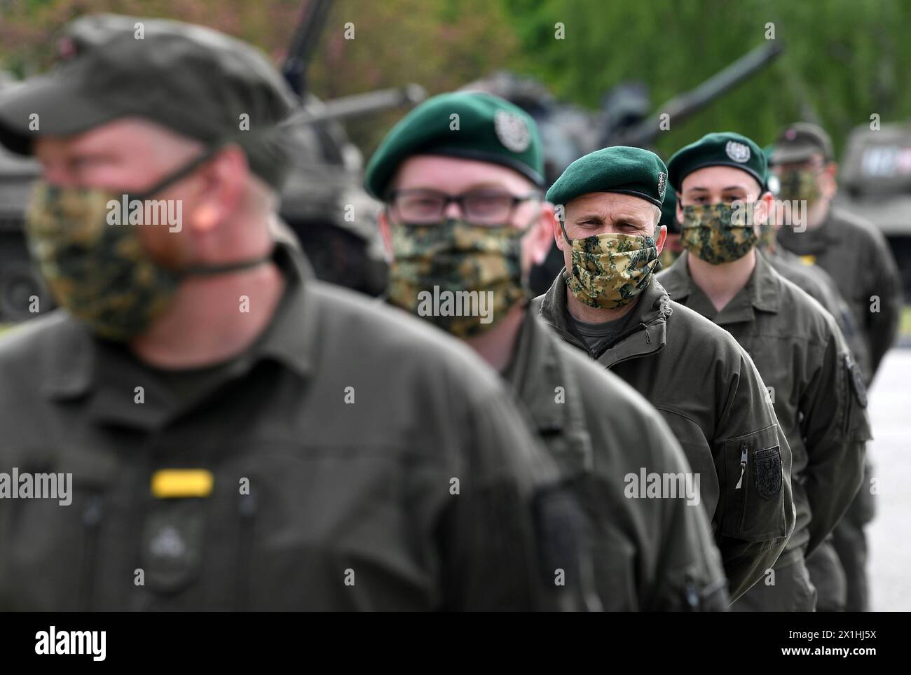 Austrian armed forces soldiers wear face masks as they line up at the ...