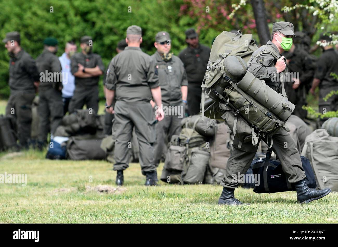 Austrian armed forces soldiers wear face masks as they line up at the ...