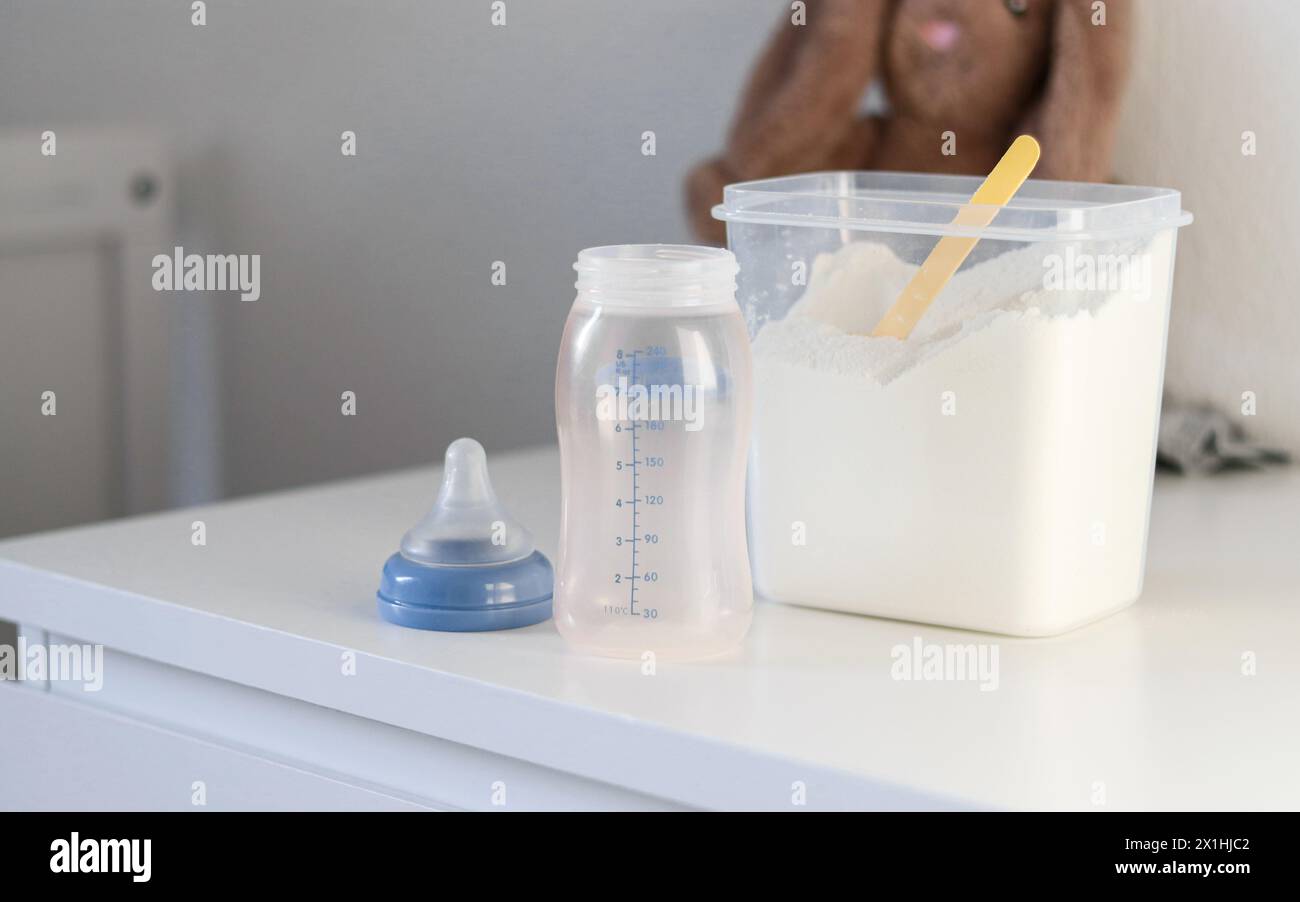 Dry powder formula milk for feeding babies in a can with yellow plastic ...