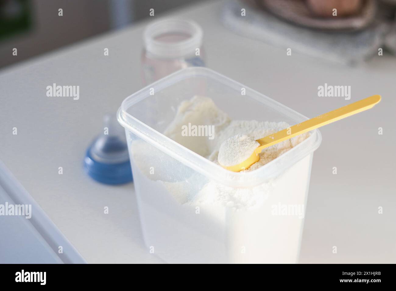 Dry powder formula milk for feeding babies in a can with yellow plastic ...