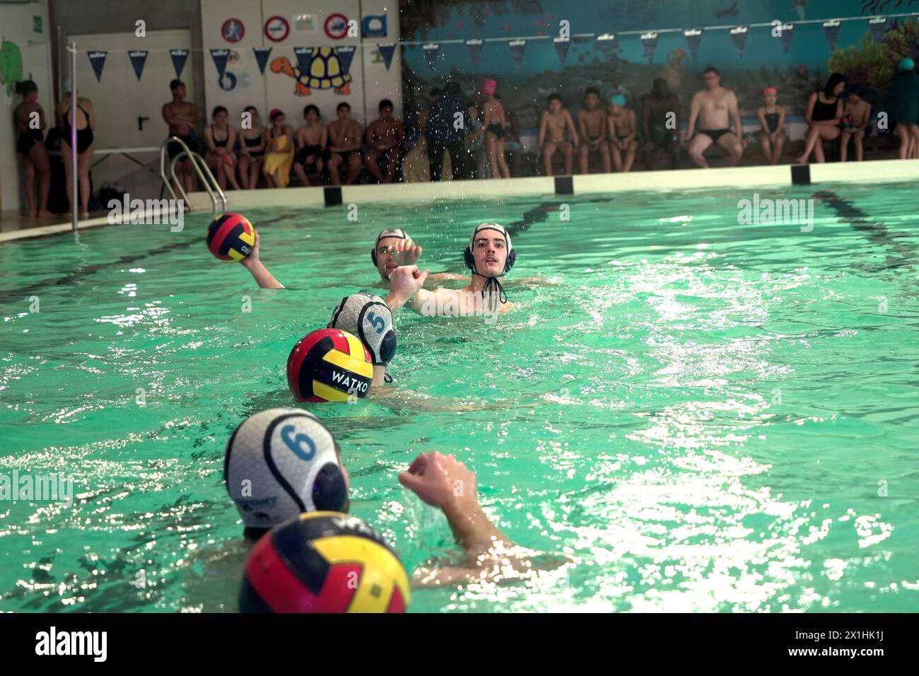 Competitors play water polo at the public swimming pool in the Paris ...