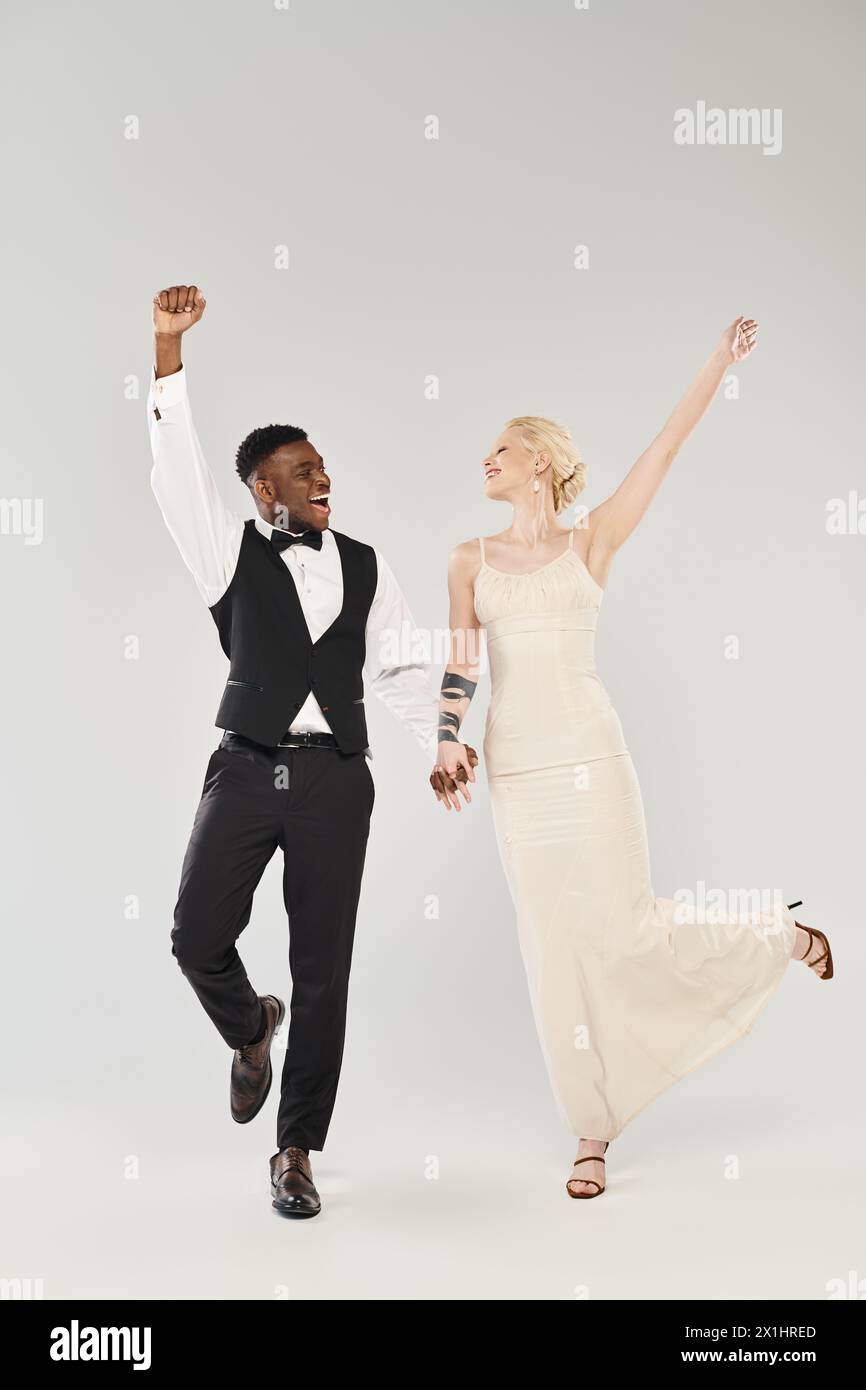 A man and woman in formal wear gracefully dance together, showcasing ...