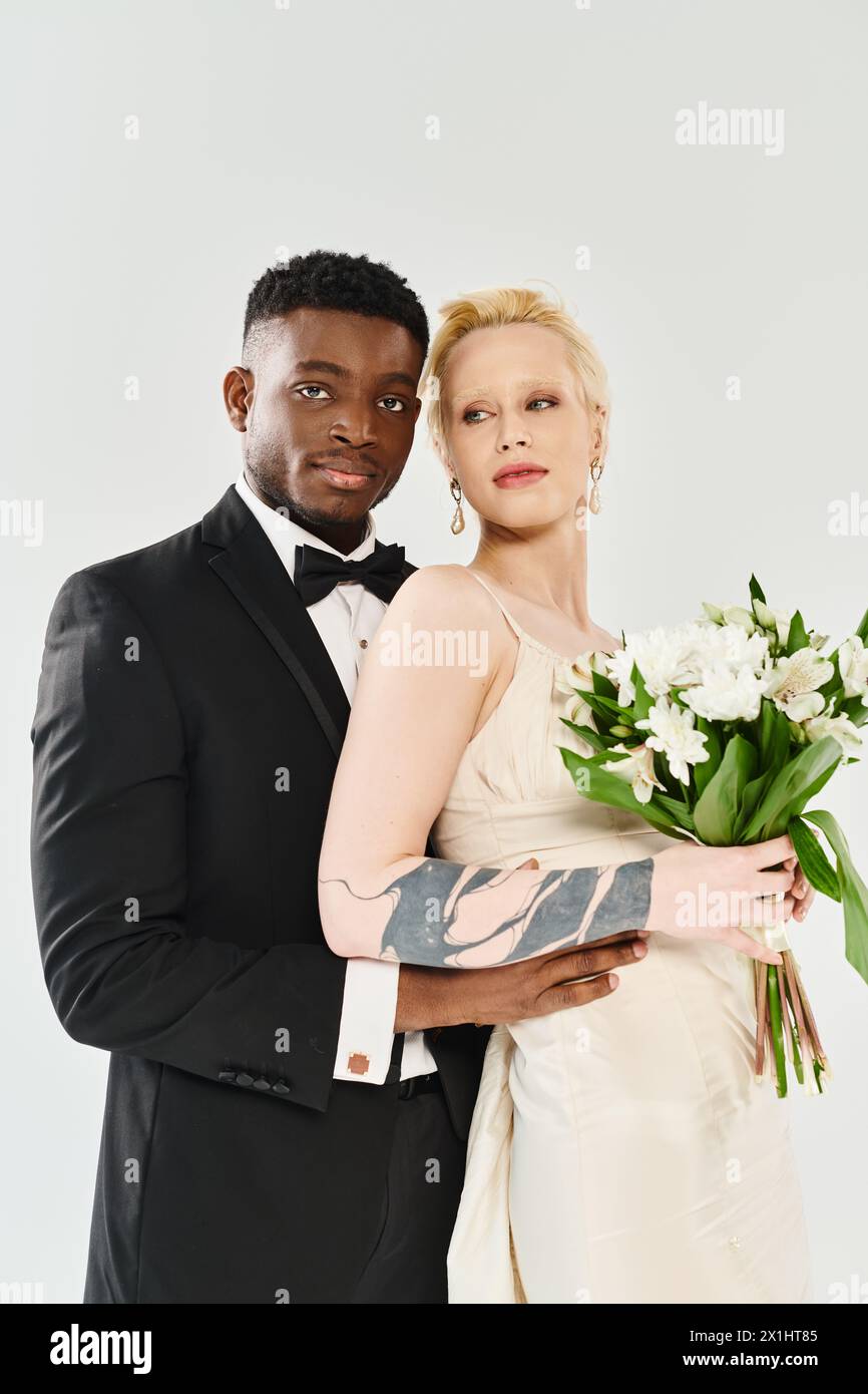 A beautiful blonde bride in a wedding dress and an African American ...