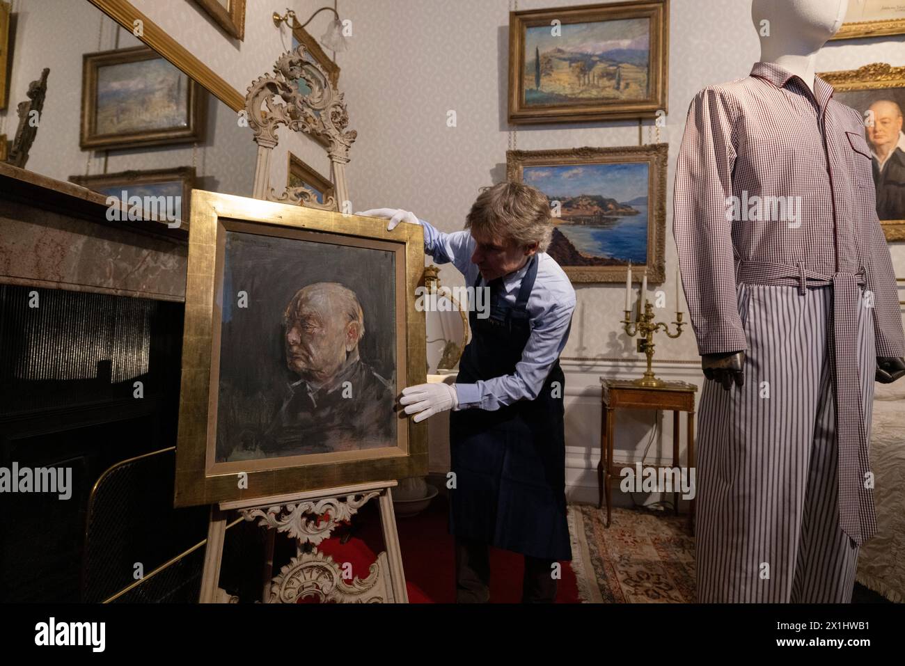 Sotheby's staff holds a portrait of the former British prime minister ...