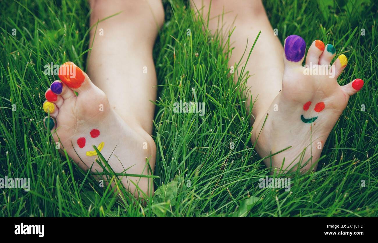 a smile drawn with paints on a child's legs Stock Photo - Alamy