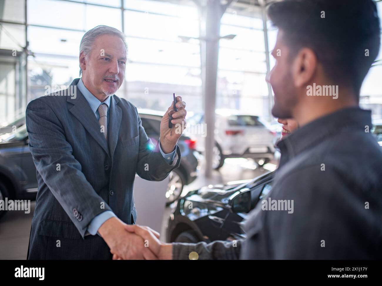 Car dealer giving keys shaking hi-res stock photography and images - Alamy