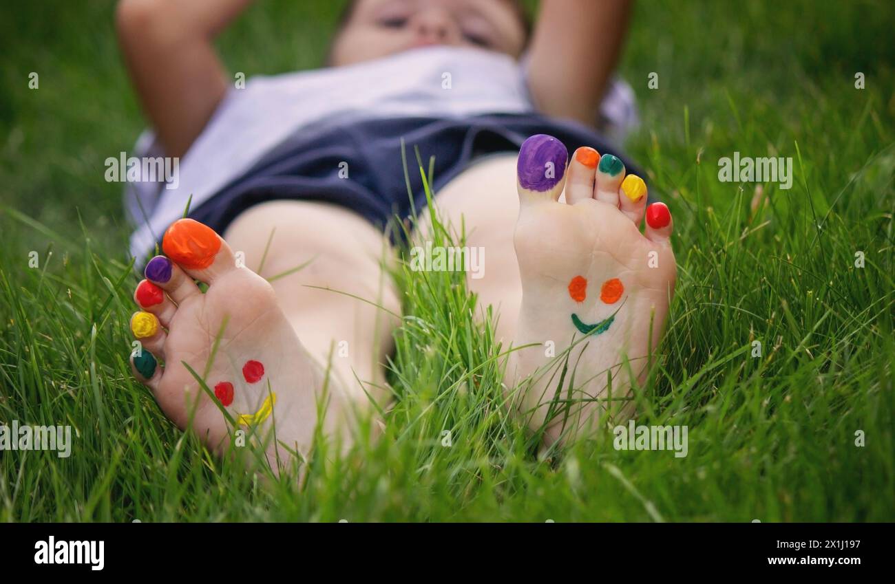 a smile drawn with paints on a child's legs Stock Photo - Alamy