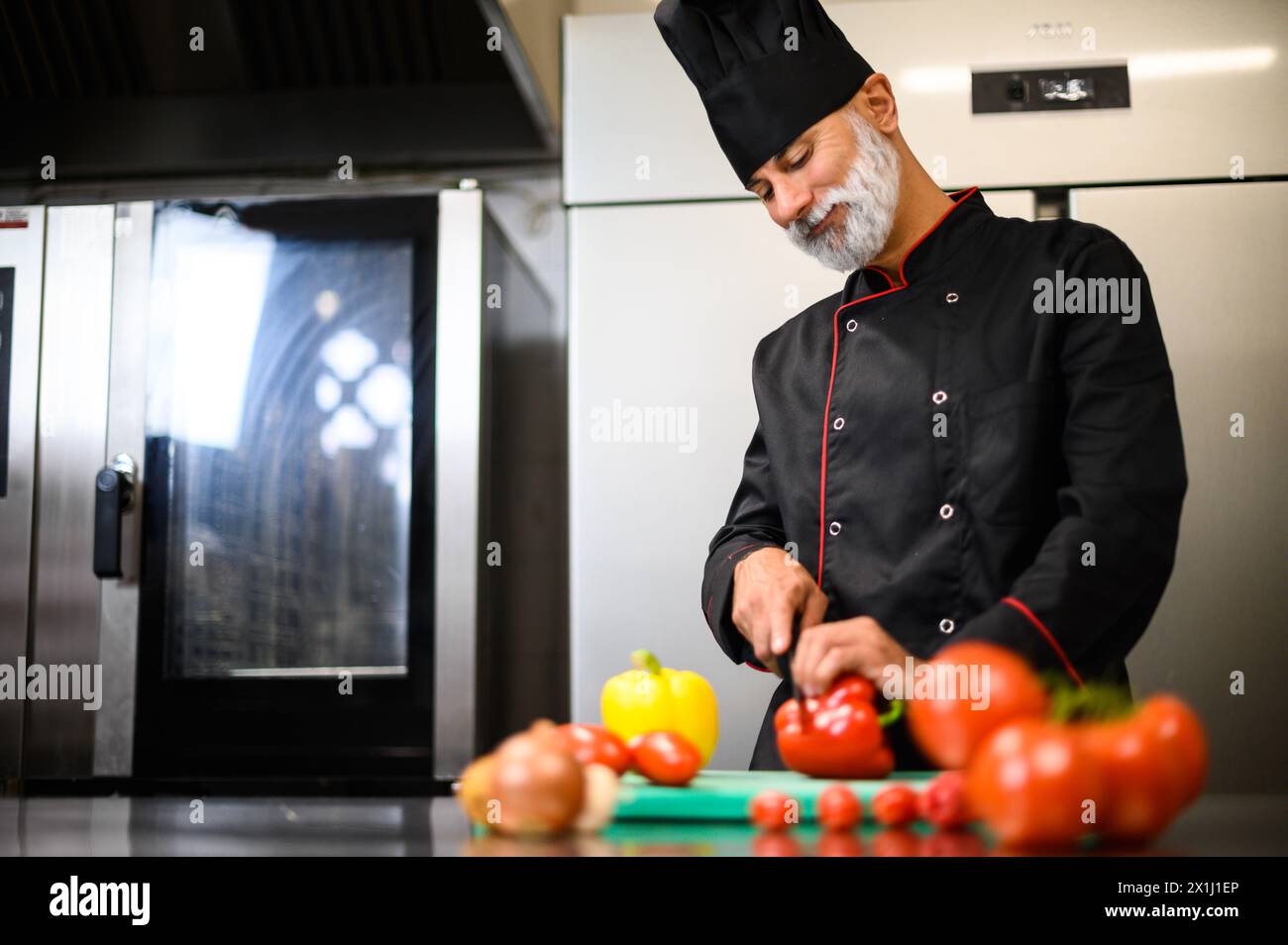 Experienced chef in professional attire prepares healthy food by ...