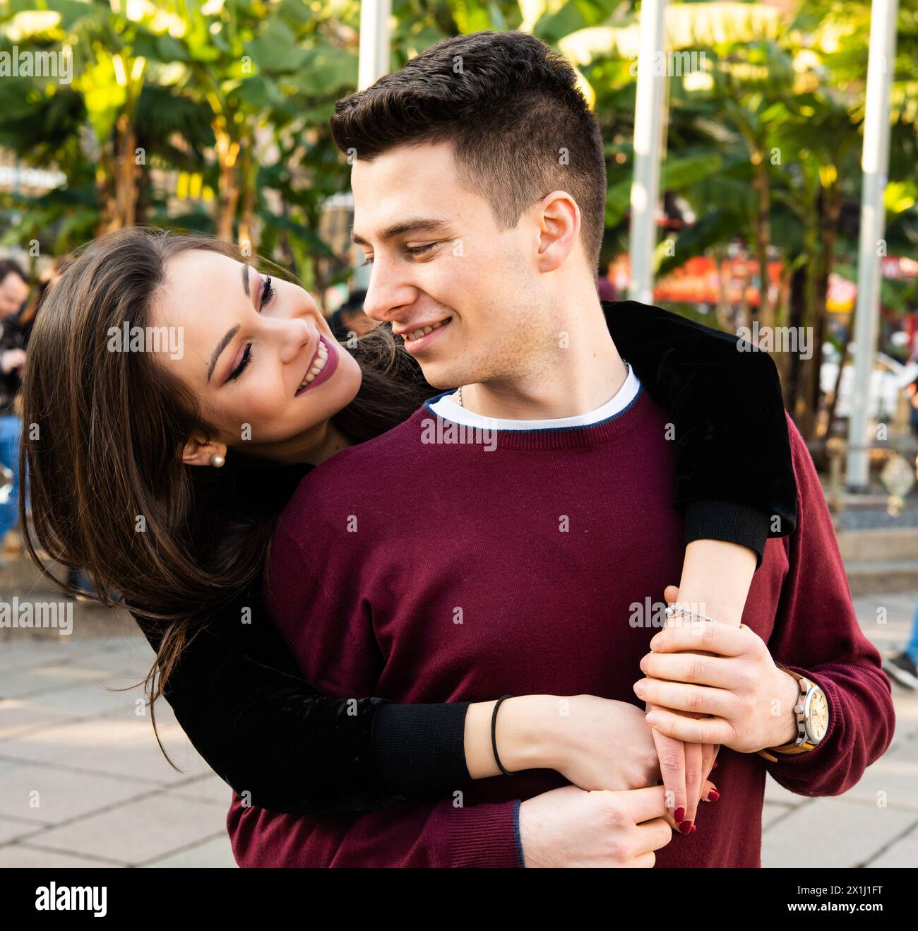 Happy young mixed race couple embracing and hugging with love and ...