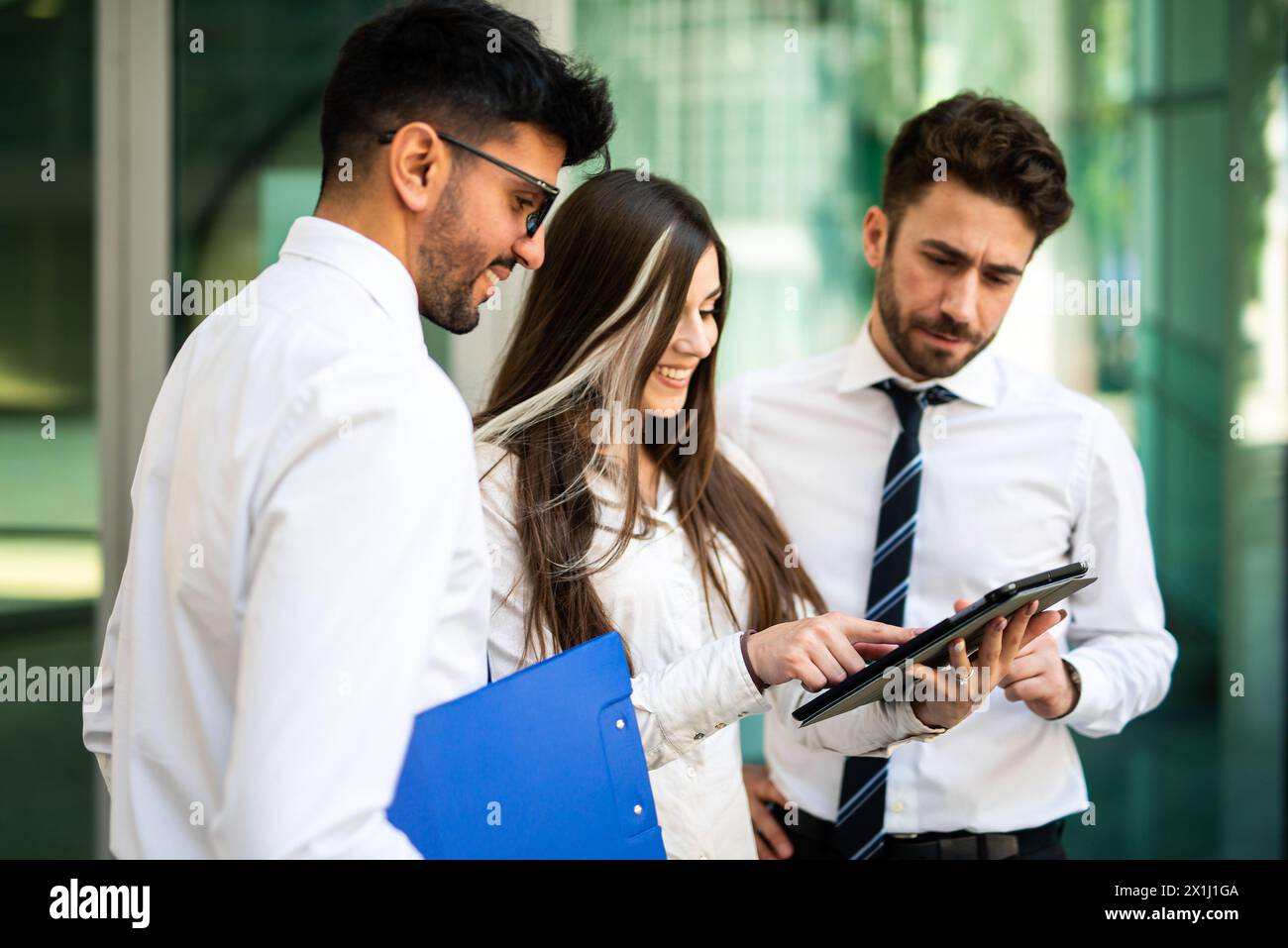 Business people using a tablet outdoor Stock Photo - Alamy