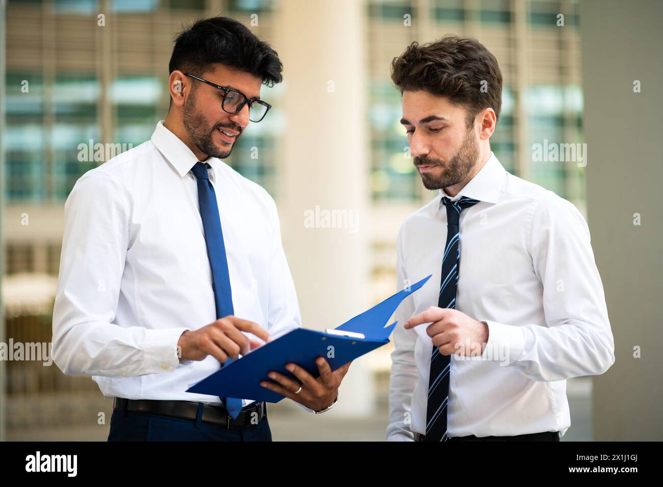 Business people reading a document together Stock Photo - Alamy