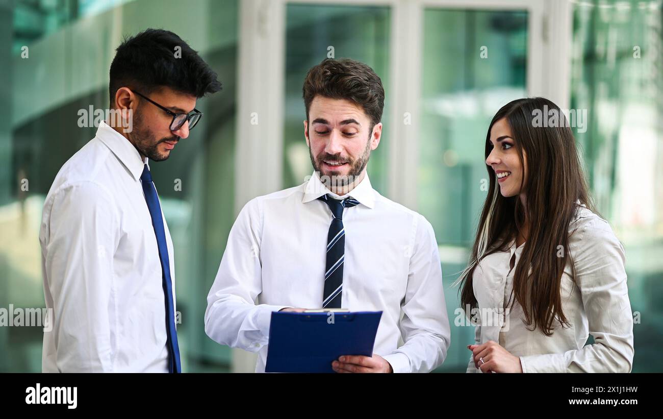 Business people reading a document together Stock Photo - Alamy