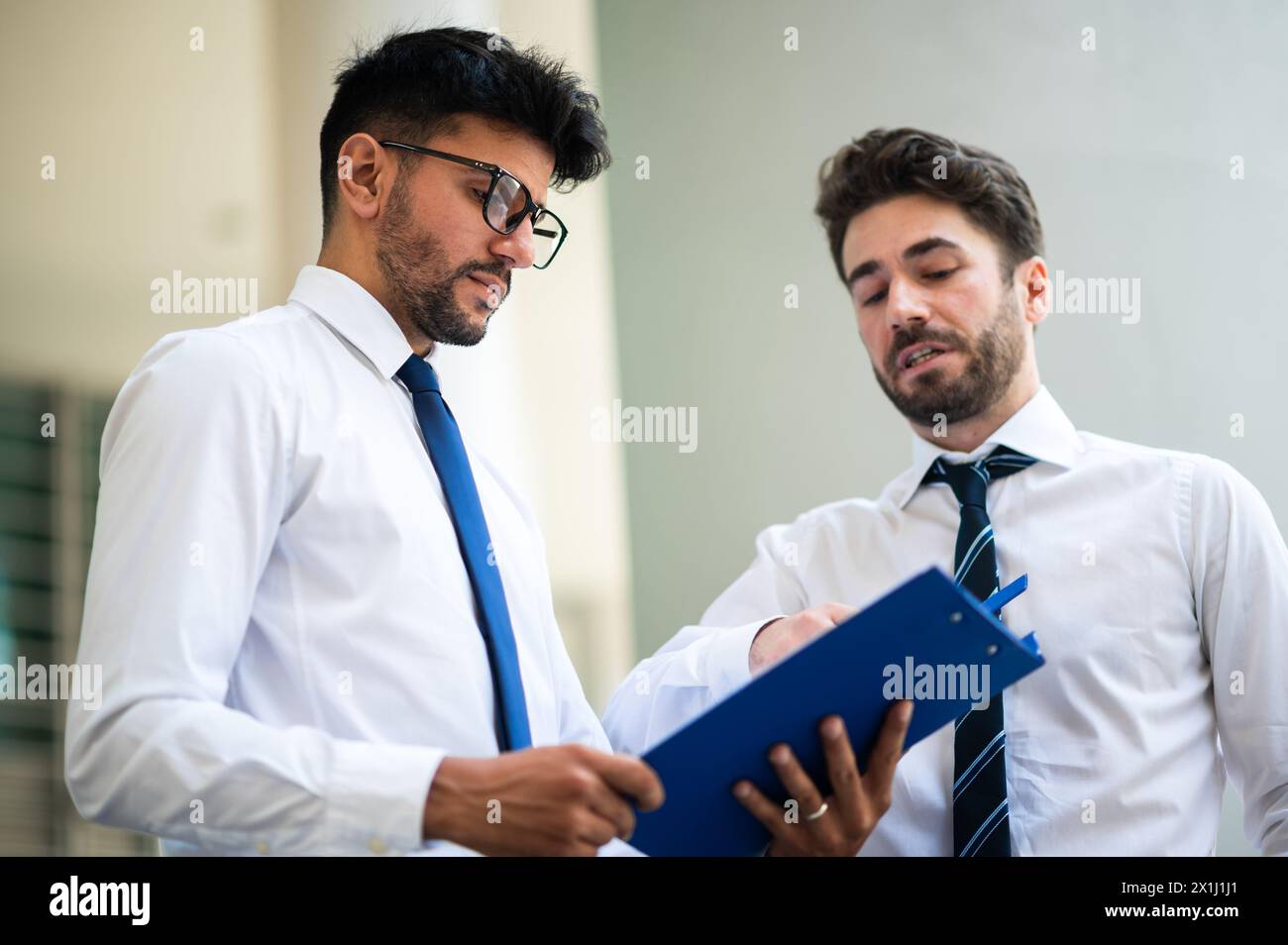 Business people reading a document together Stock Photo - Alamy