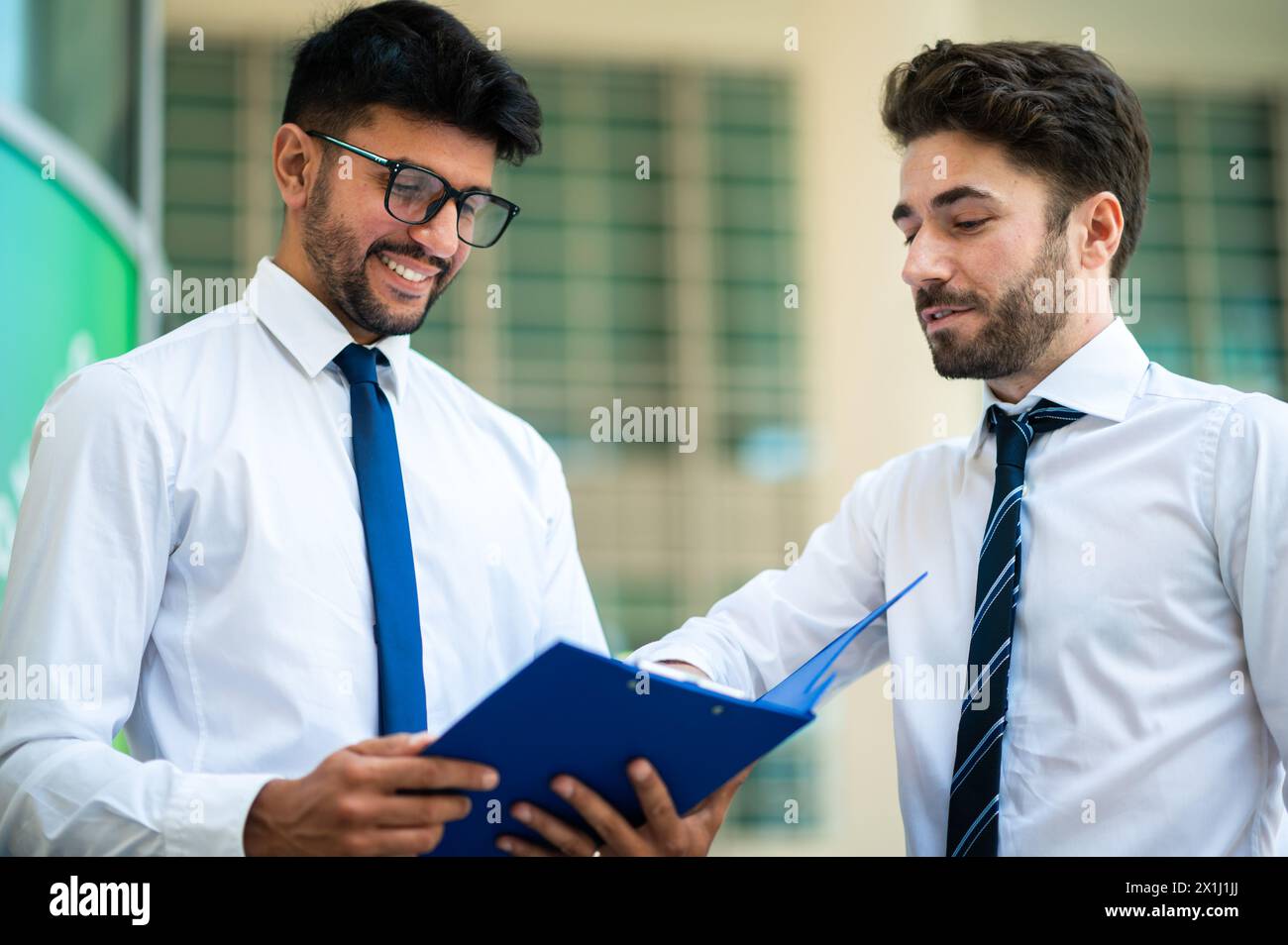 Business people reading a document together Stock Photo - Alamy