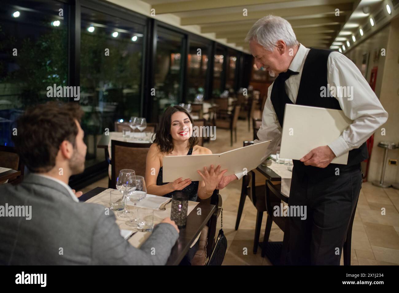 Couple ordering dinner in a luxury restaurant Stock Photo - Alamy