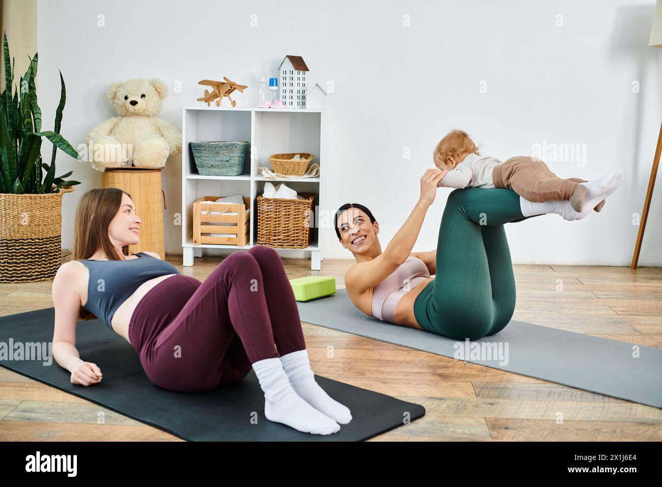 A young mother gracefully practices yoga with her baby, guided by an ...