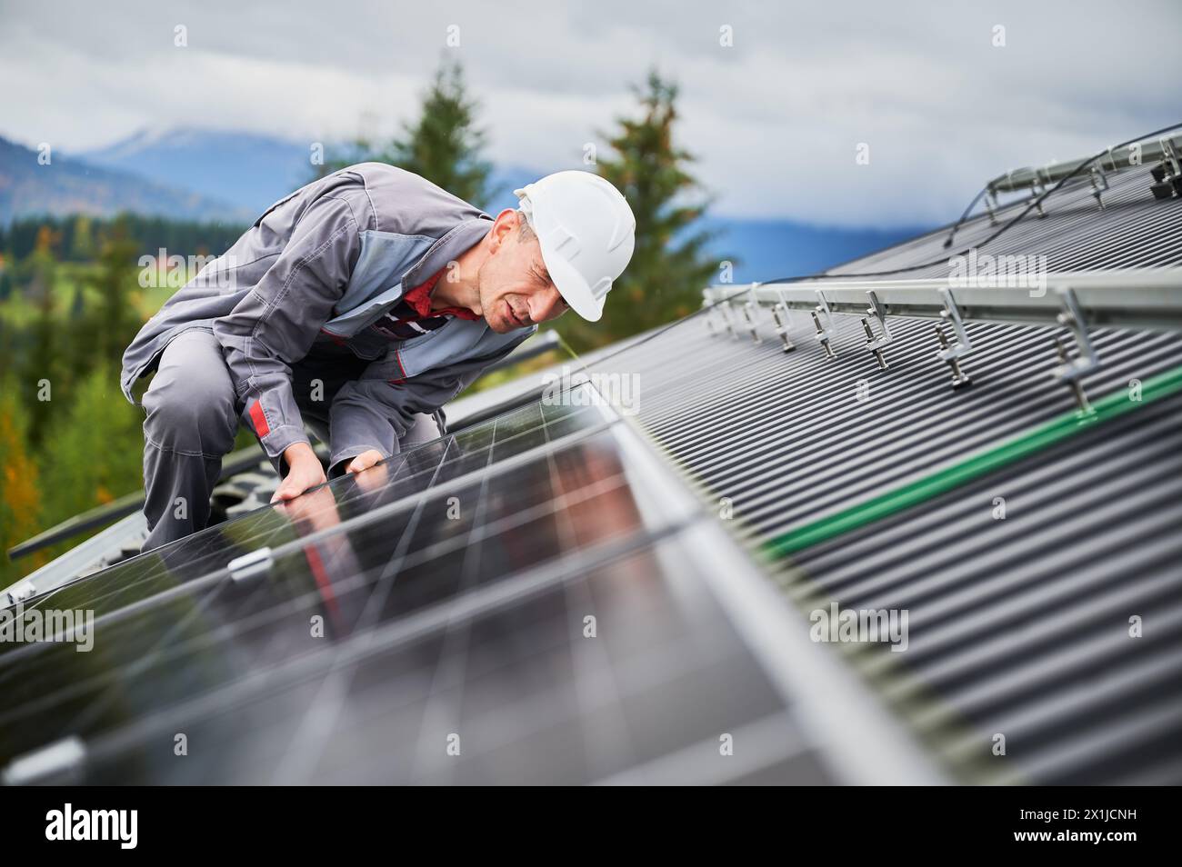 Competent technician adjusting position of solar panel. Solar ...
