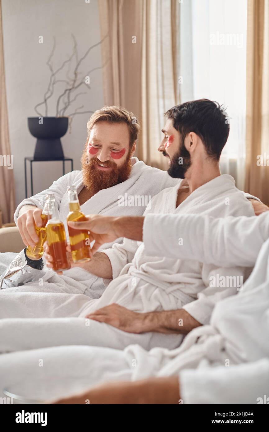 Three diverse and cheerful men in bathrobes enjoy each others company ...
