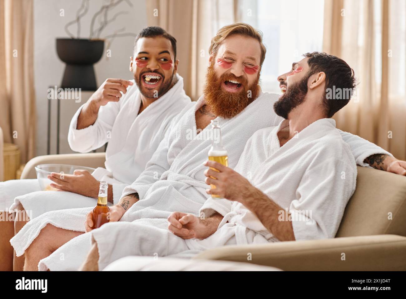 Three cheerful, diverse men in bathrobes share laughter and camaraderie ...