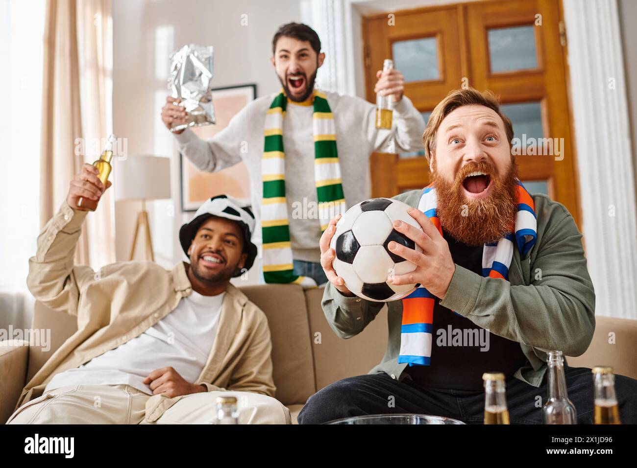 Three cheerful, diverse men in casual attire sitting on a couch ...