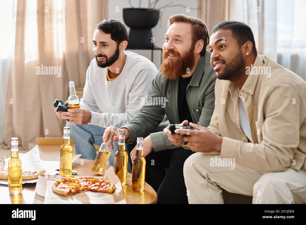 Three cheerful, handsome, interracial men in casual attire are sitting ...