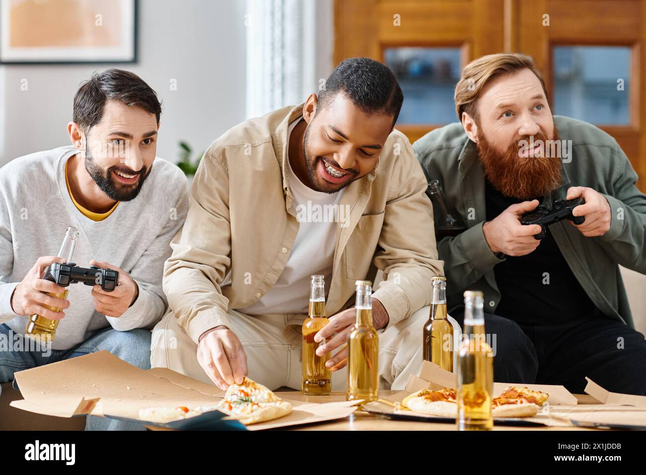 Three cheerful, interracial men in casual attire sit around a table ...