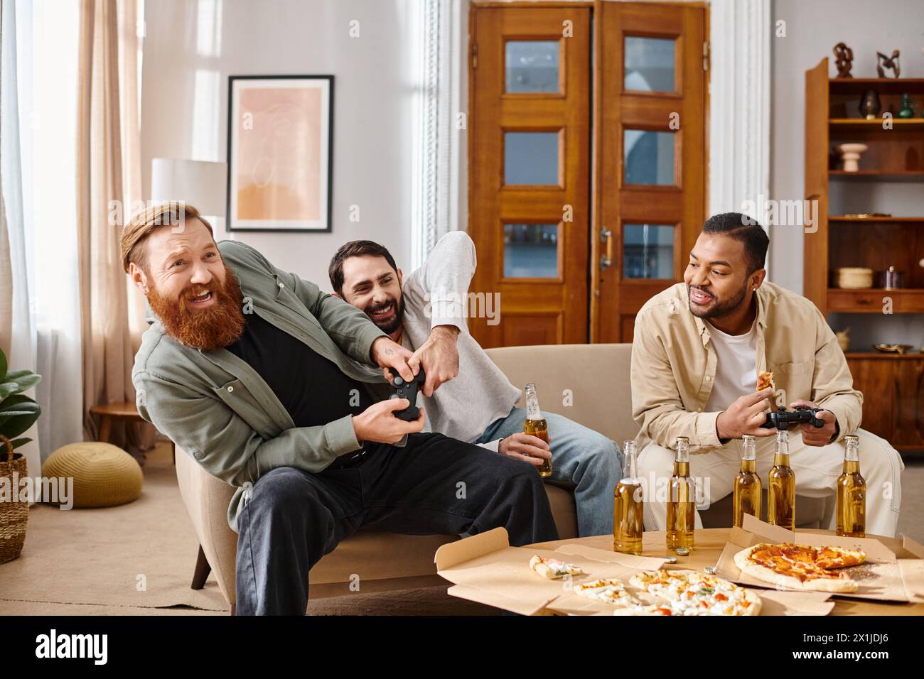 Three cheerful men of different ethnicities sit around a table ...