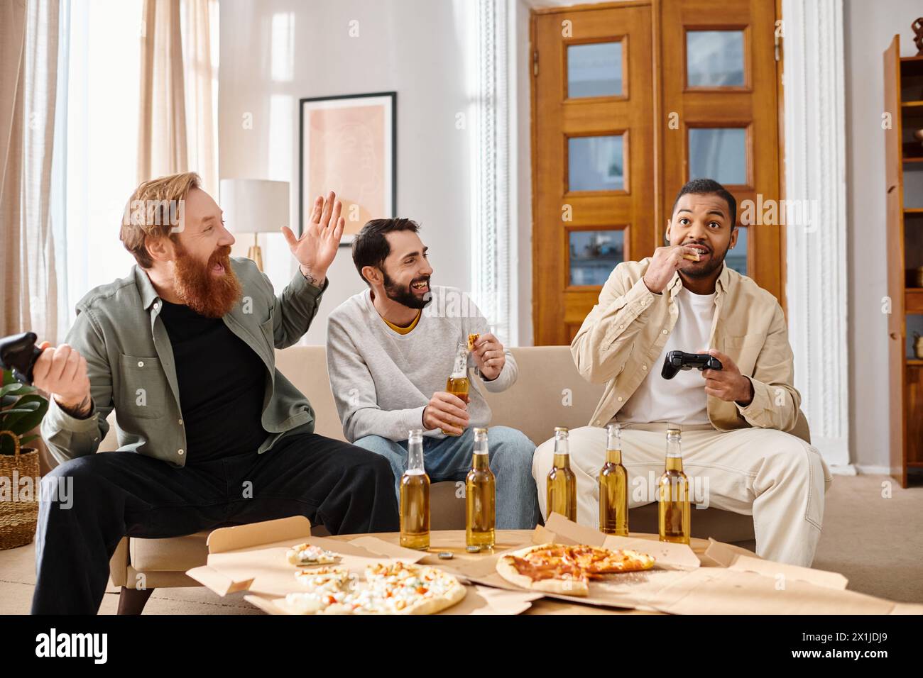 Three handsome, cheerful men of different races share pizza and beer at ...