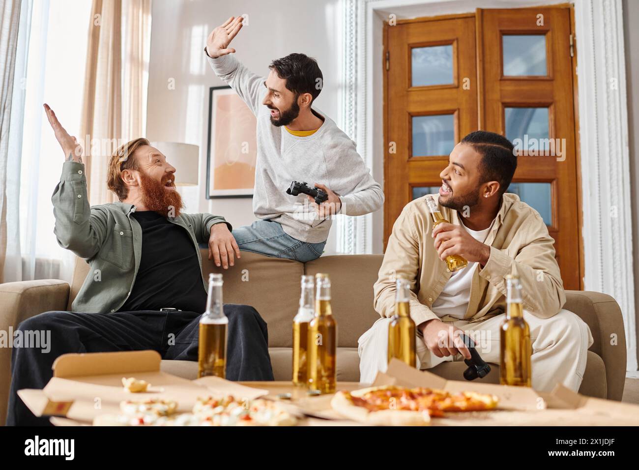 Three handsome, cheerful men from different backgrounds sit together on ...